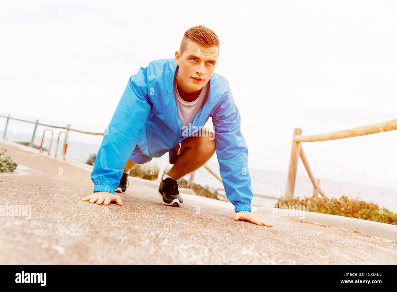 Male runner getting ready to start his race Stock Photo - Alamy