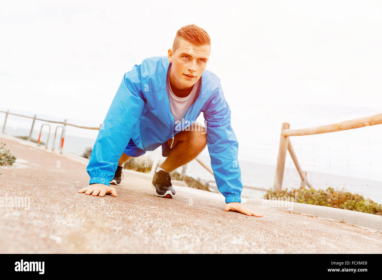 Male runner getting ready to start his race Stock Photo - Alamy