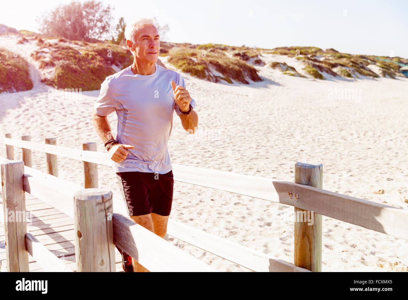Healthy running man on beach Stock Photo - Alamy
