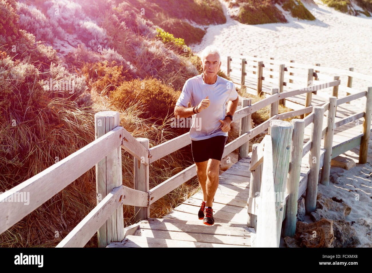 Healthy running man on beach Stock Photo - Alamy