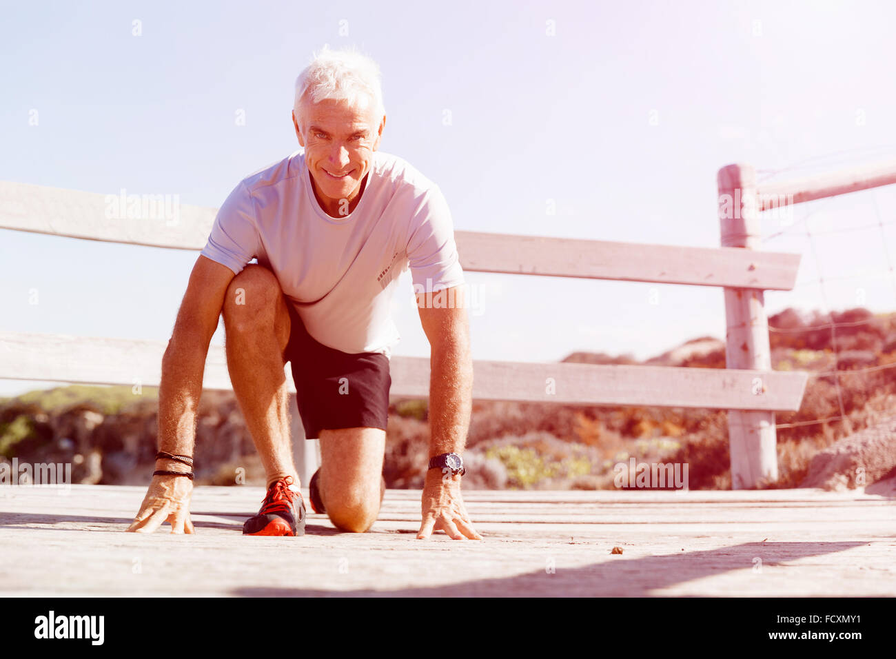 Male runner getting ready to start his race Stock Photo - Alamy