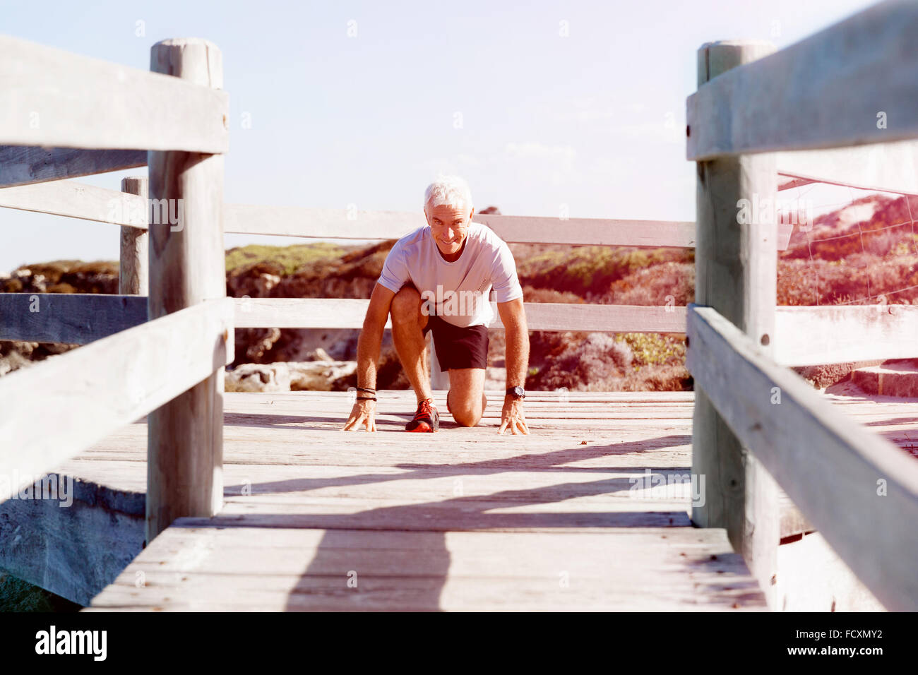 Male runner getting ready to start his race Stock Photo - Alamy