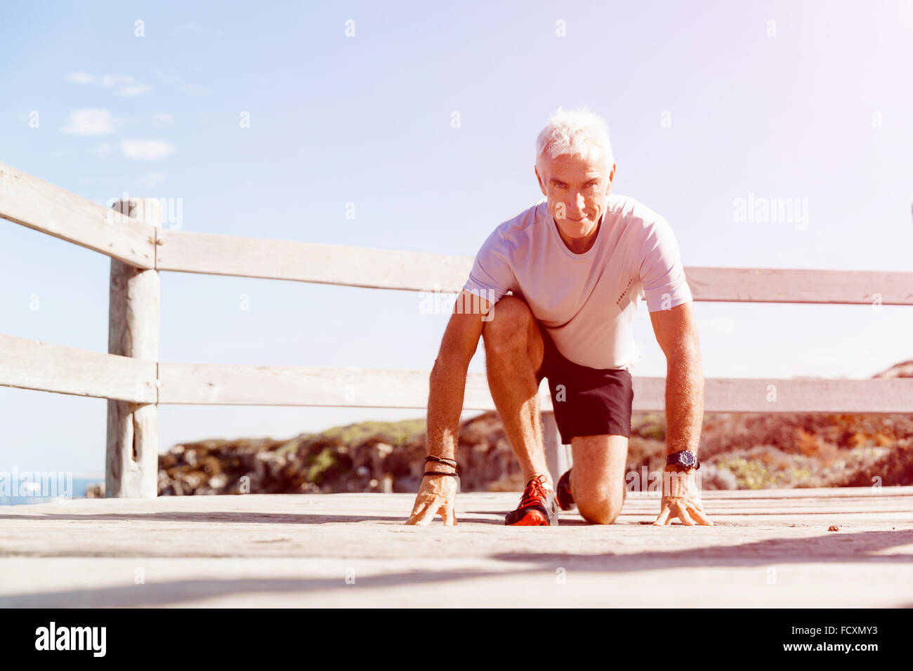 Male runner getting ready to start his race Stock Photo - Alamy