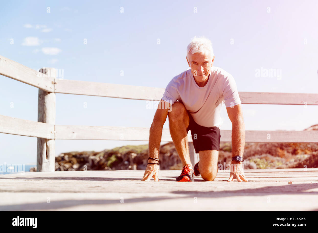 Male runner getting ready to start his race Stock Photo - Alamy