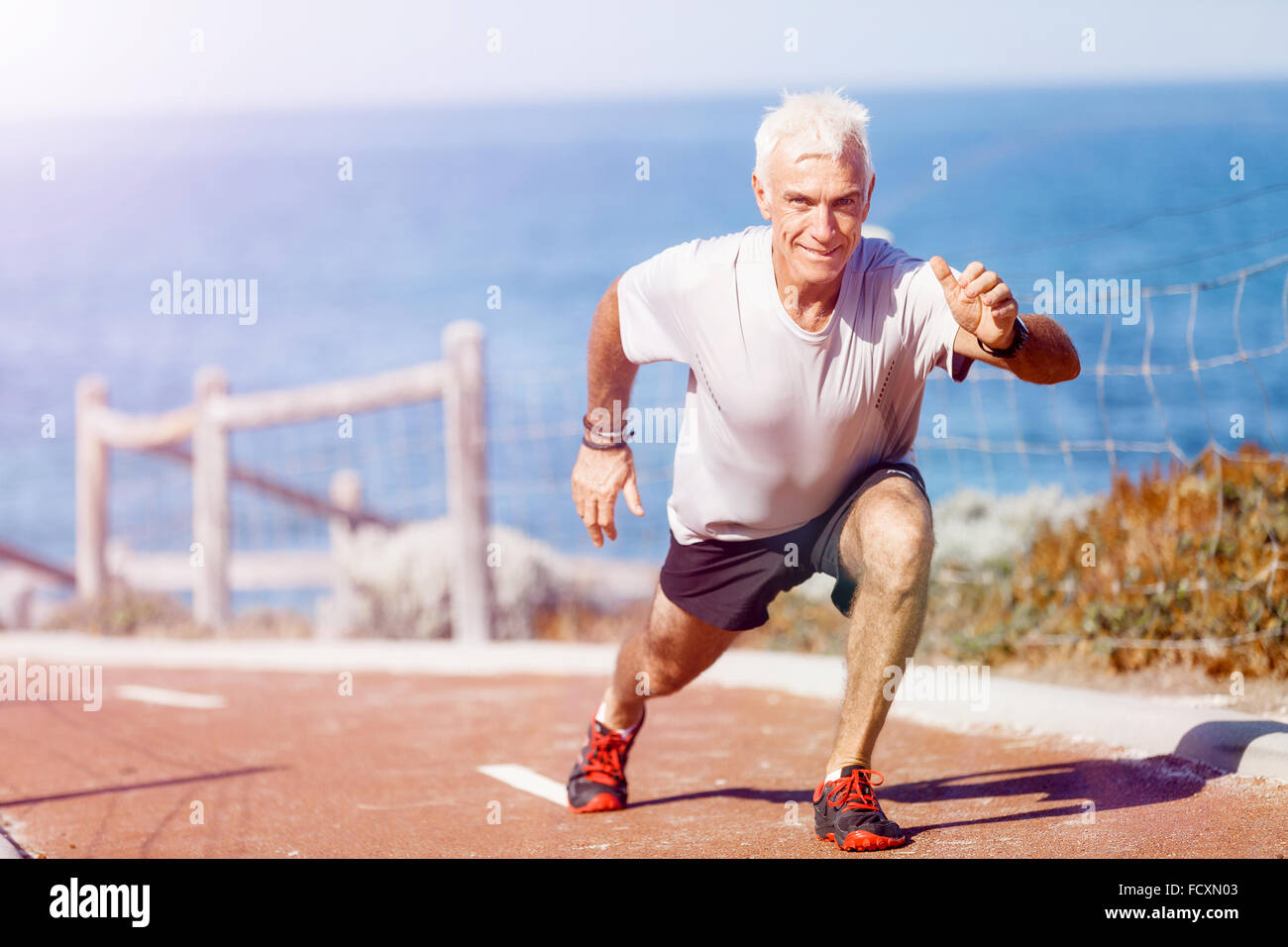 Male runner getting ready to start his race Stock Photo - Alamy