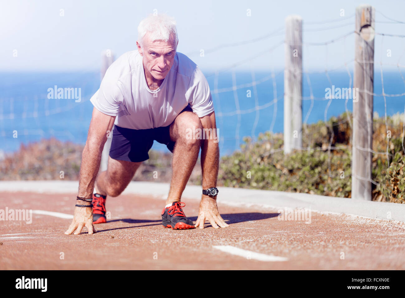 Male runner getting ready to start his race Stock Photo - Alamy