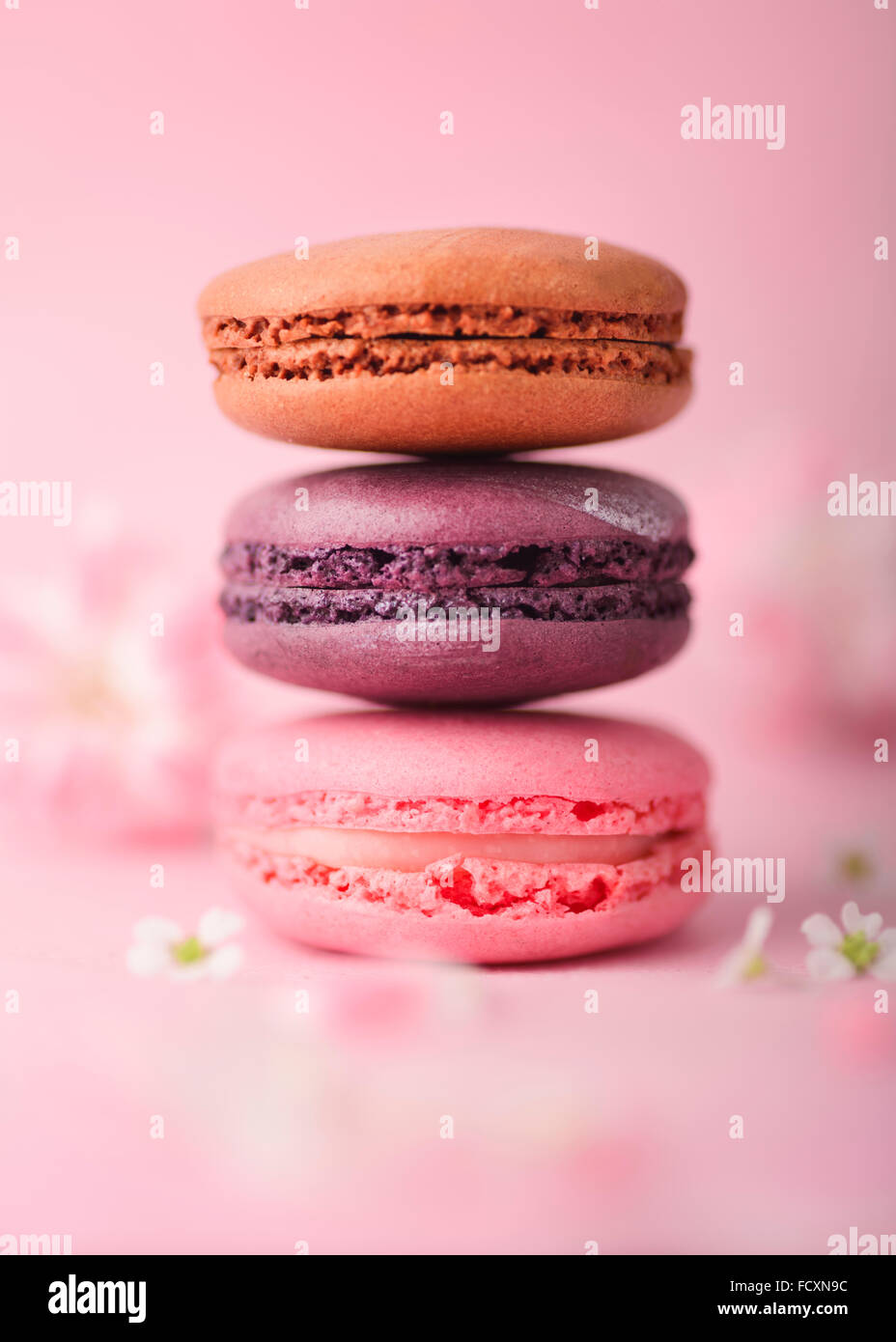 Stack of three different macarons on pink backround Stock Photo - Alamy