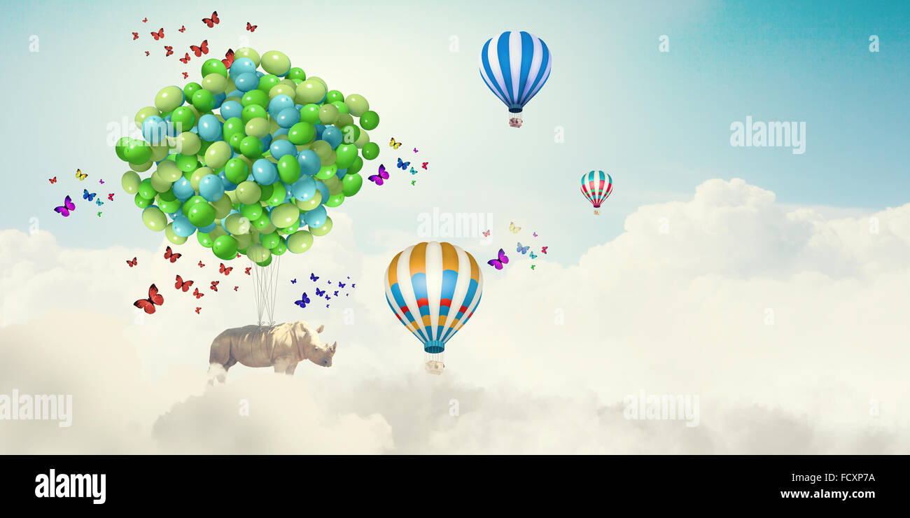 Sunny image of giraffe flying high in sky on aerostat Stock Photo - Alamy