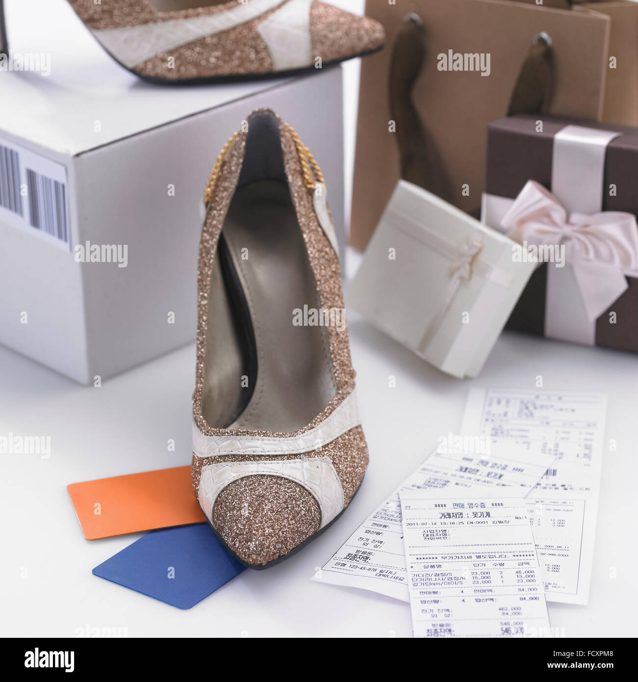 High-heeled shoes, shopping bag and present boxes with credit cards and ...
