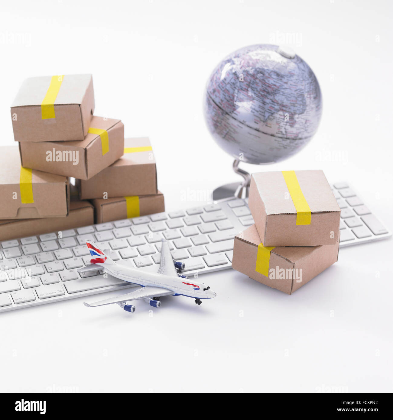 Delivery boxes with globe, airplane and keyboard Stock Photo - Alamy