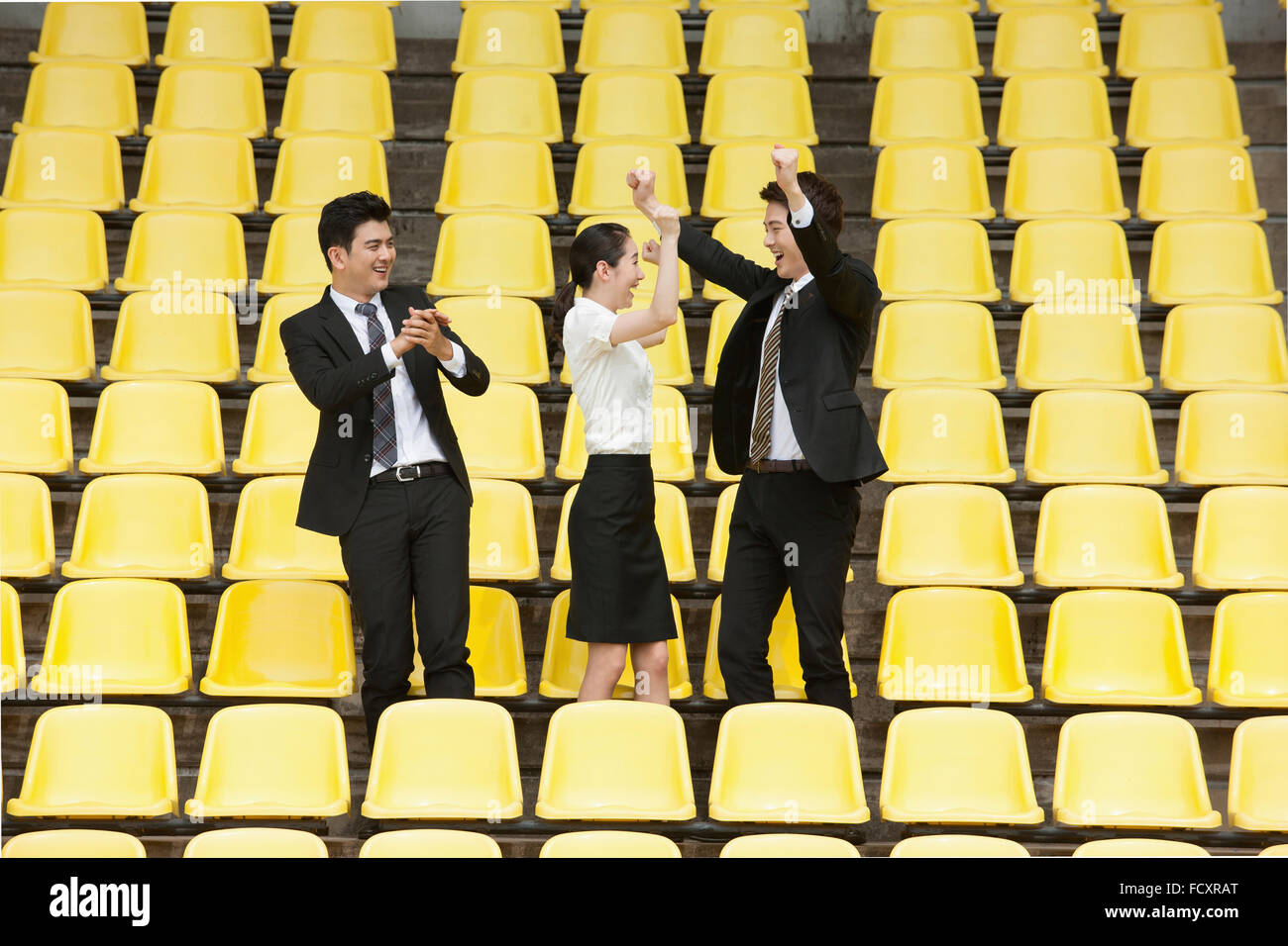 Business people clapping and cheering at stadium seats Stock Photo - Alamy