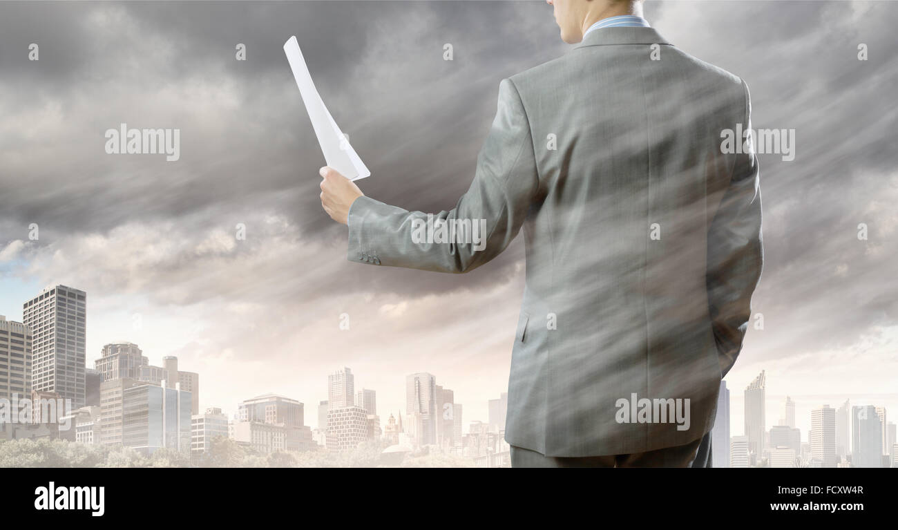 Back view of businessman reading documents in hand Stock Photo - Alamy