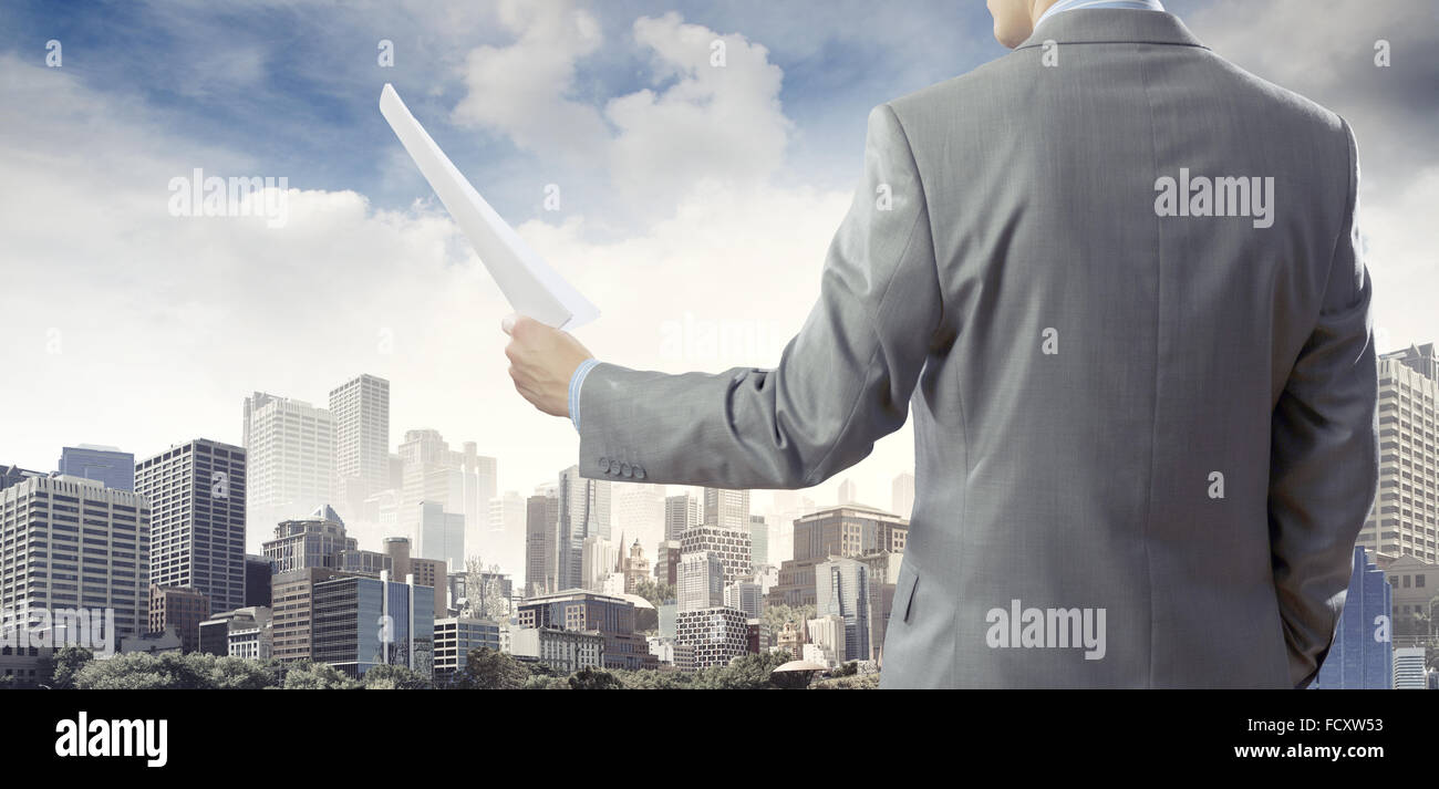 Back view of businessman reading documents in hand Stock Photo - Alamy