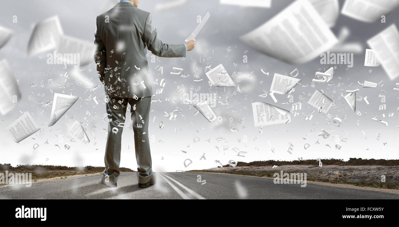 Back view of businessman reading documents in hand Stock Photo - Alamy