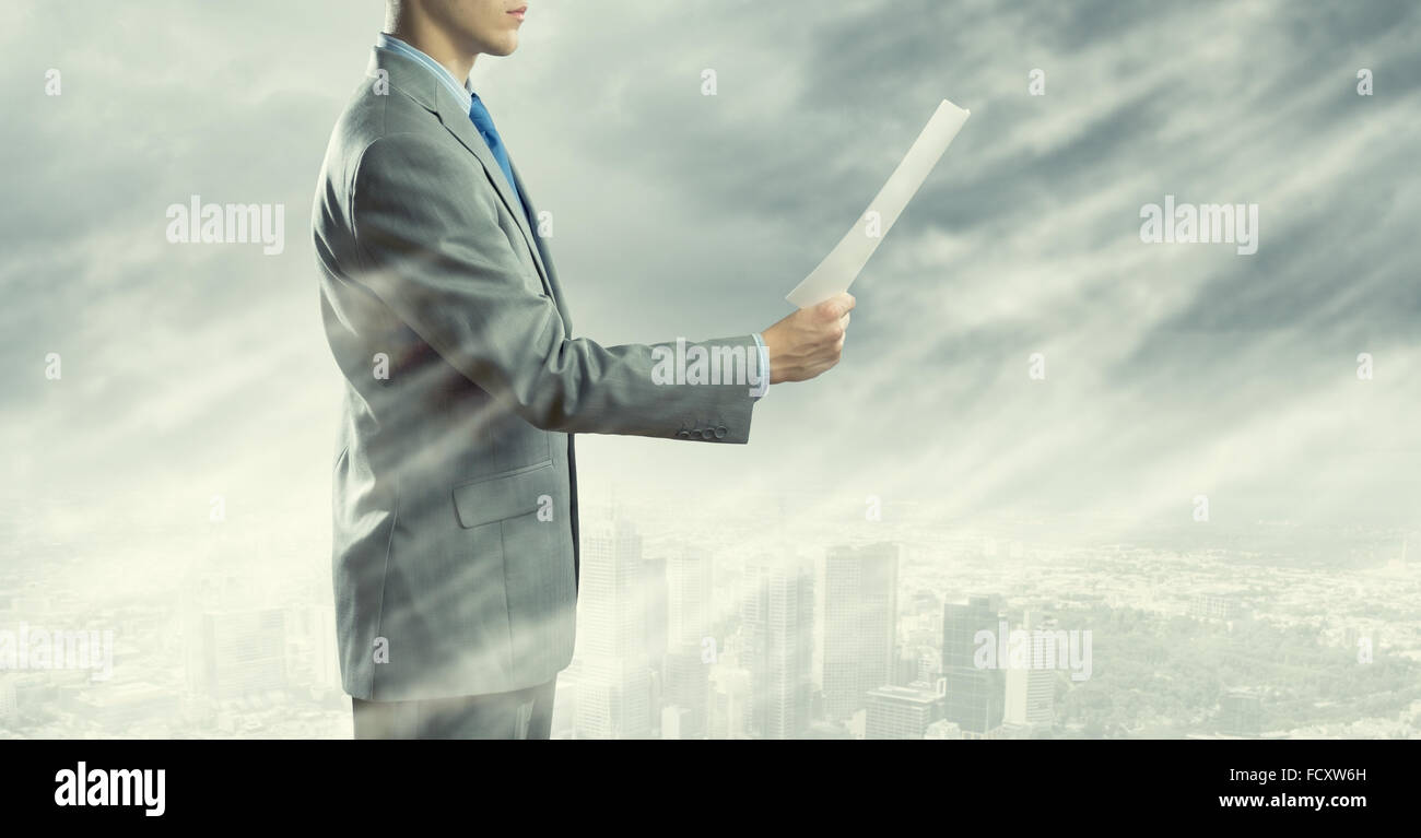 Back view of businessman reading documents in hand Stock Photo - Alamy