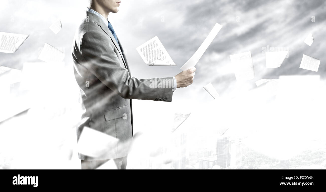 Back view of businessman reading documents in hand Stock Photo - Alamy