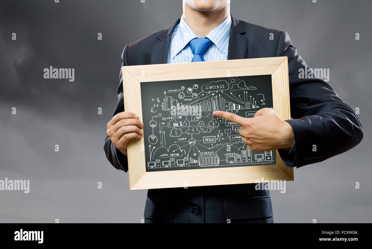 Close up of businessman holding frame with business sketch Stock Photo ...