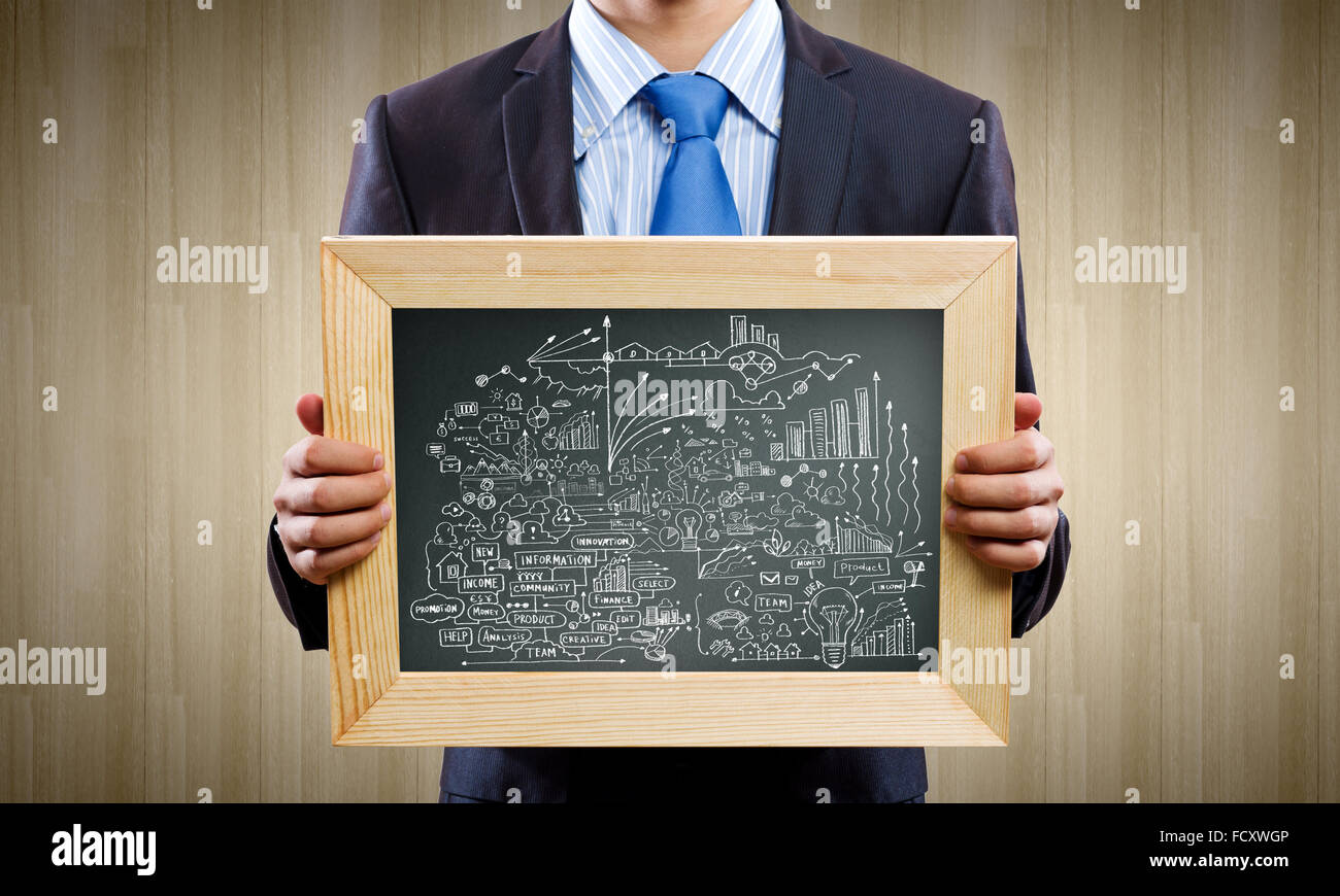 Close up of businessman holding frame with business sketch Stock Photo ...