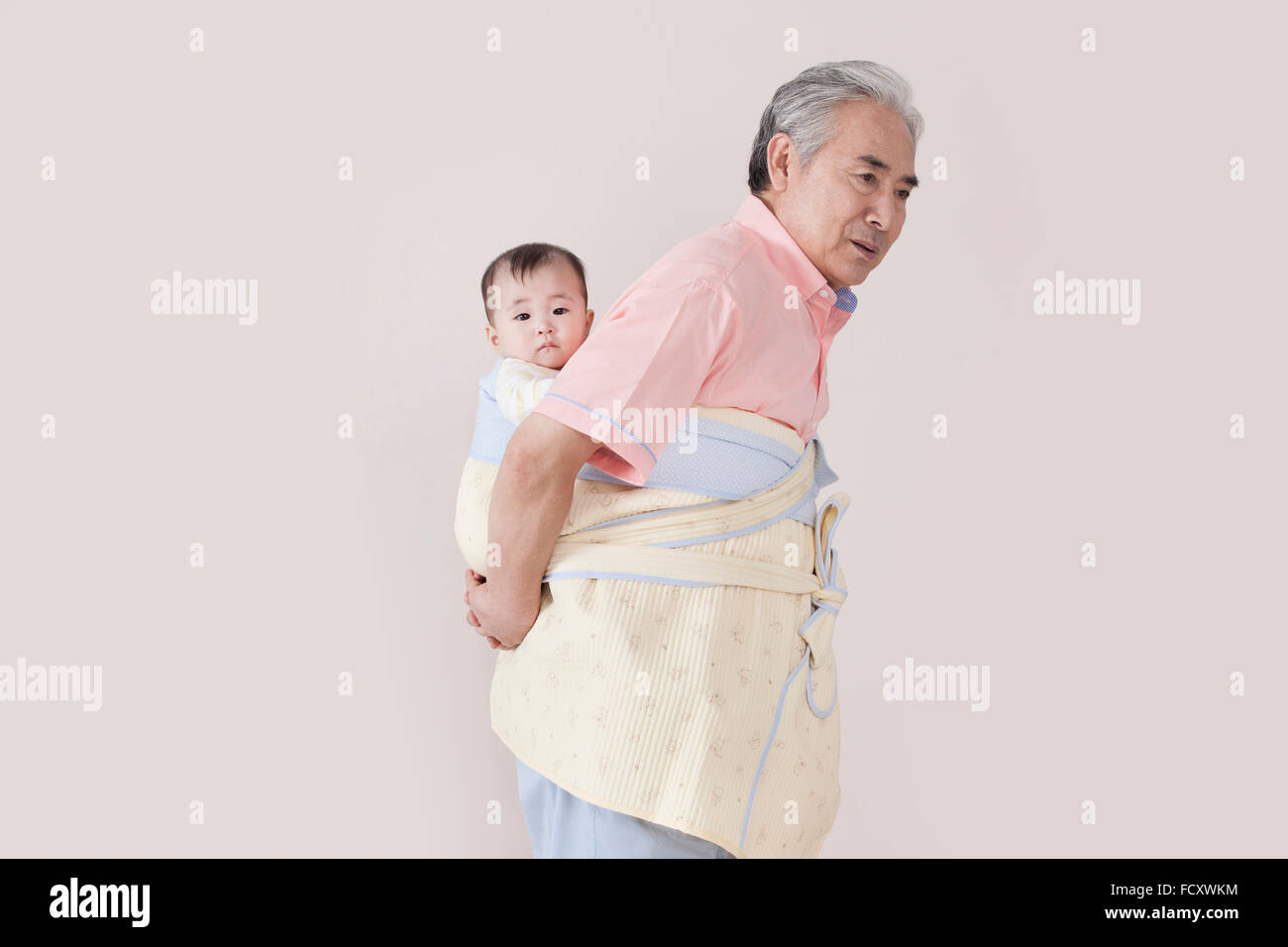 Side view portrait of old man carrying a baby with a blanket Stock ...