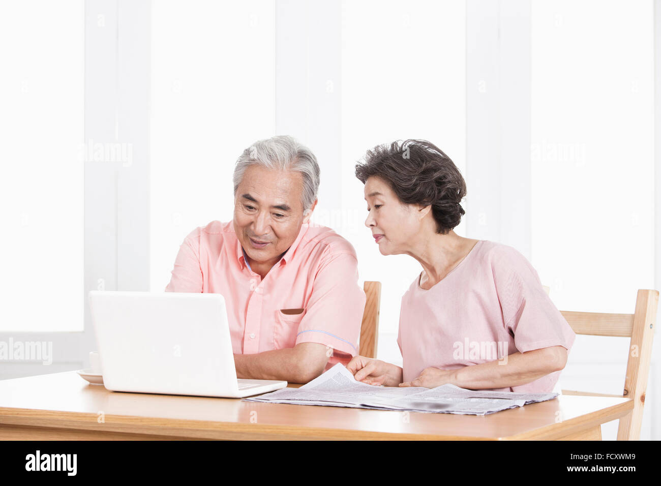 Old couple using a notebook computer together Stock Photo - Alamy