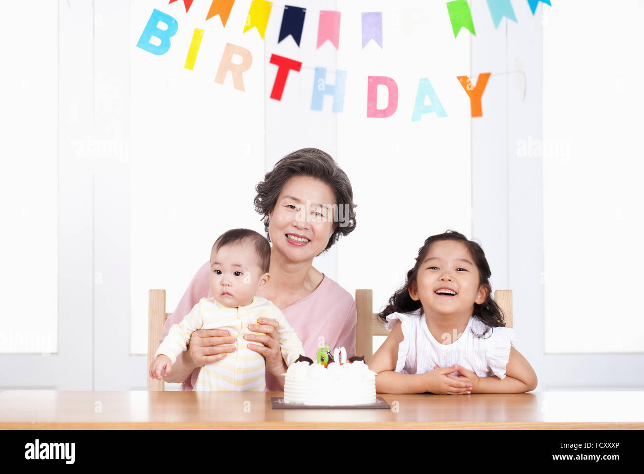 Portrait of grandmother and grandchildren at birthday party Stock Photo ...