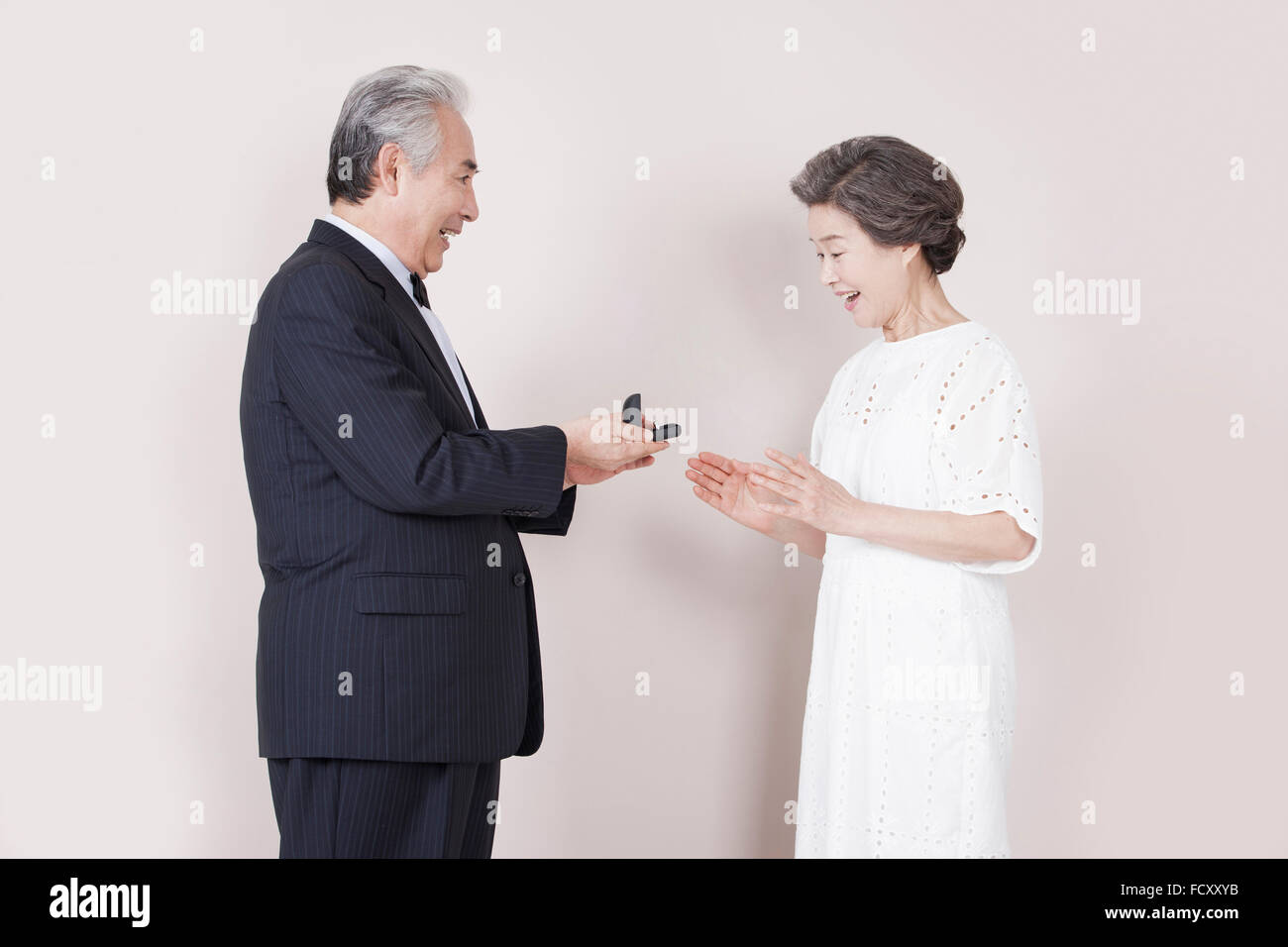 Side view portrait of old man confessing his love to an old woman with ...