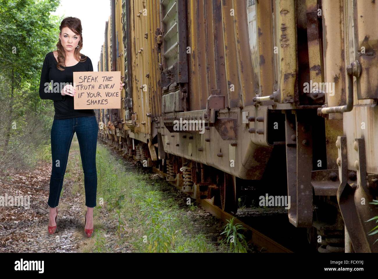 A beautiful young woman holding up a sign Stock Photo - Alamy