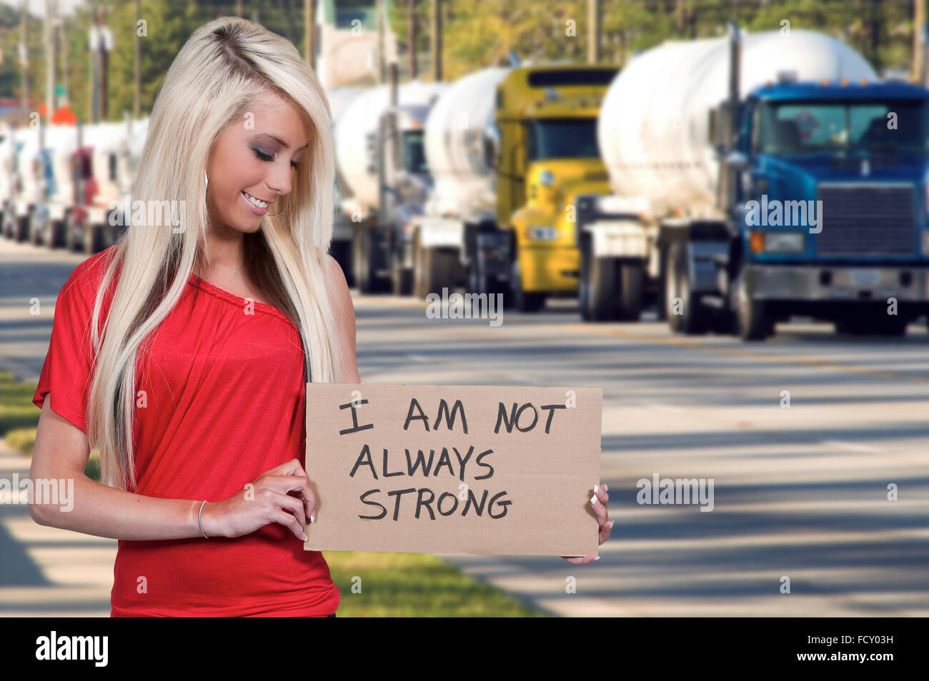 A beautiful young woman holding up a sign that says I am not always ...