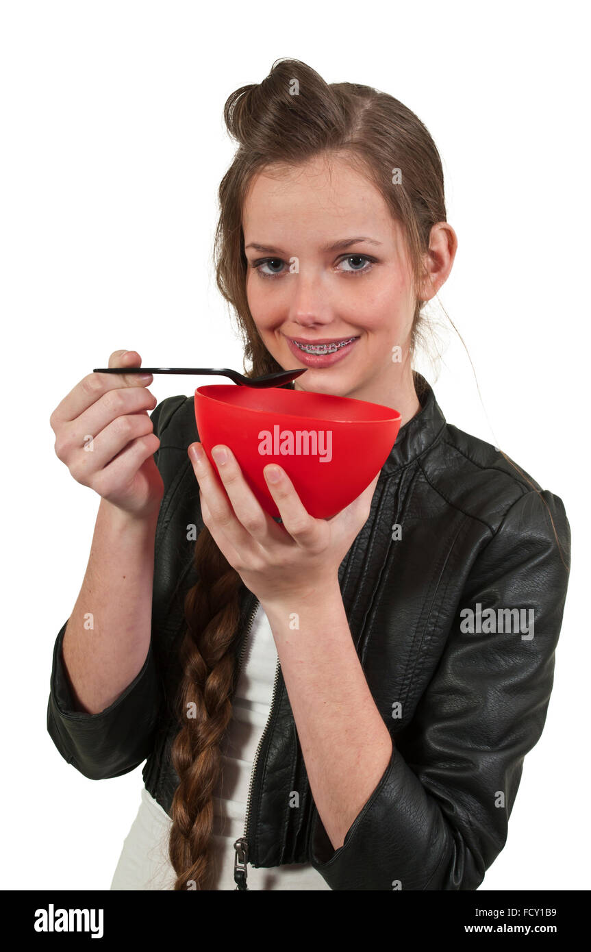 A beautiful woman eating food from a bowl Stock Photo - Alamy