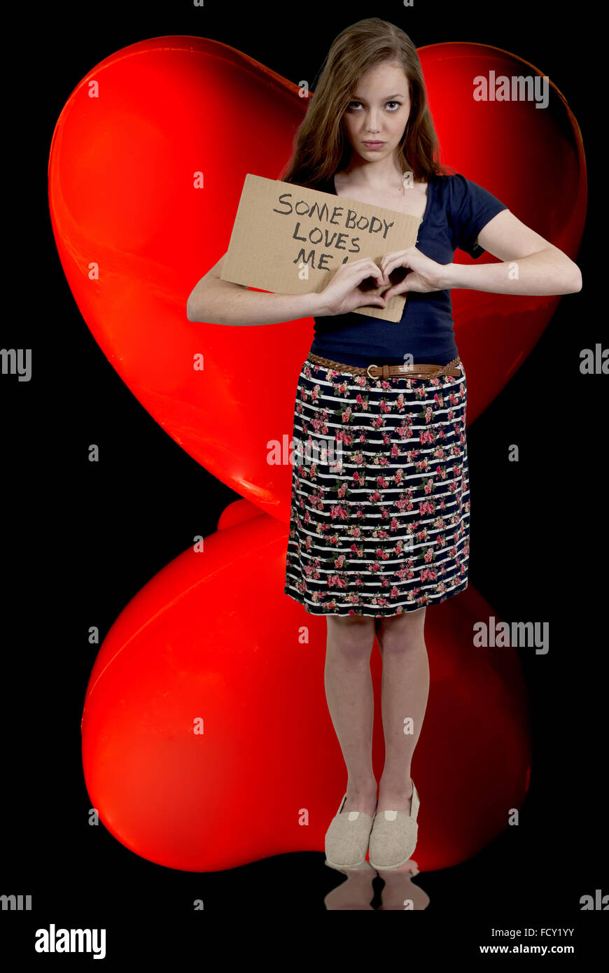 A beautiful young woman holding up a sign that says I am not always ...