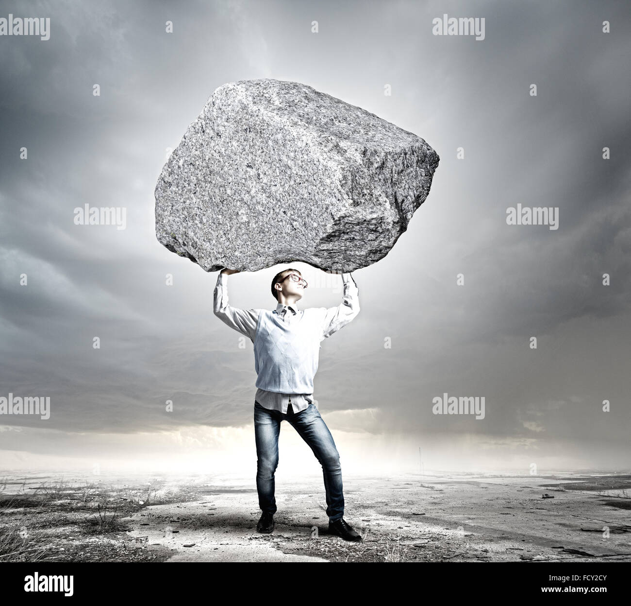 Young strong man holding huge stone above head Stock Photo - Alamy