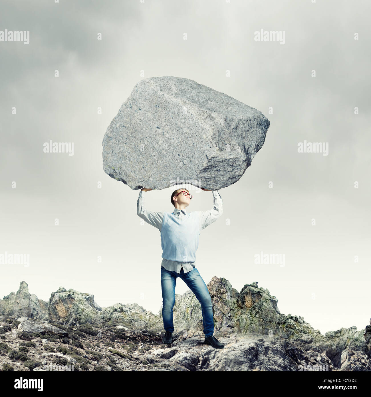 Boy lifting rock hi-res stock photography and images - Alamy