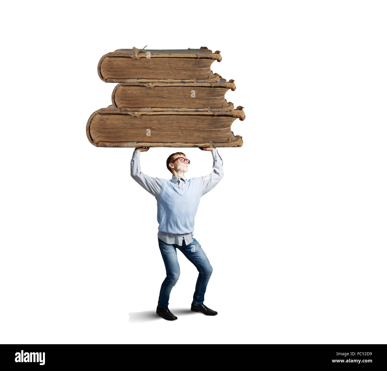 Young man holding huge book above head Stock Photo - Alamy