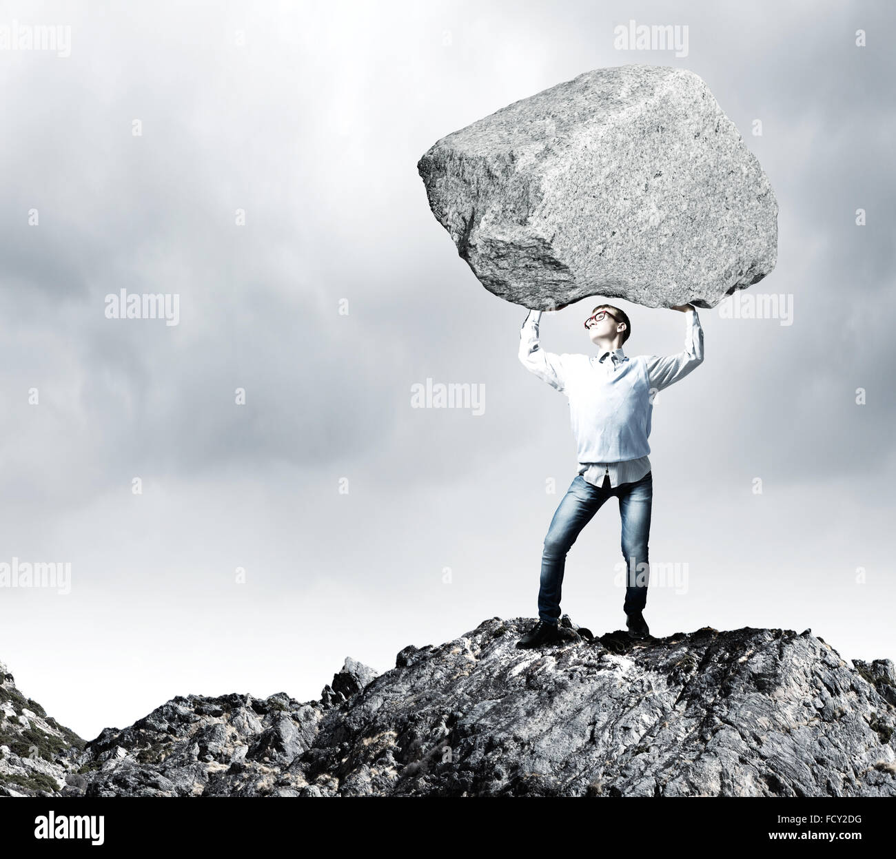 Man holding rock above head hi-res stock photography and images - Alamy