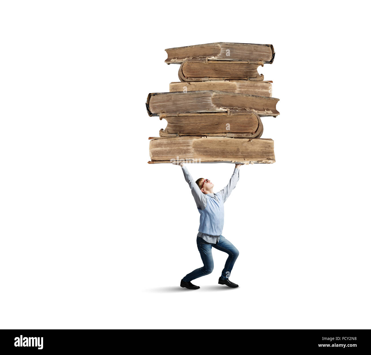 Young man holding huge book above head Stock Photo - Alamy