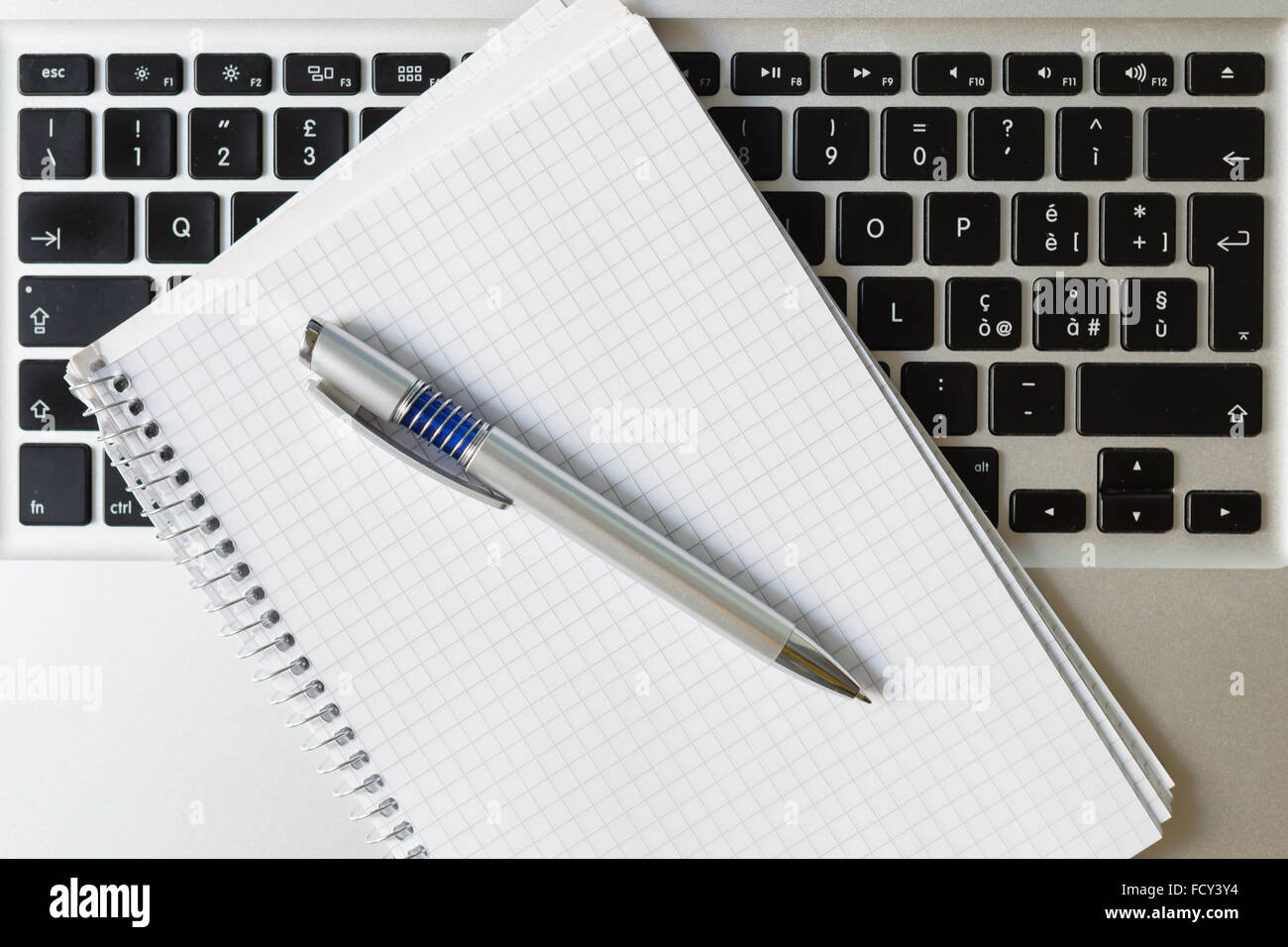 silver laptop computer with notepad, pen, keyboard Stock Photo - Alamy