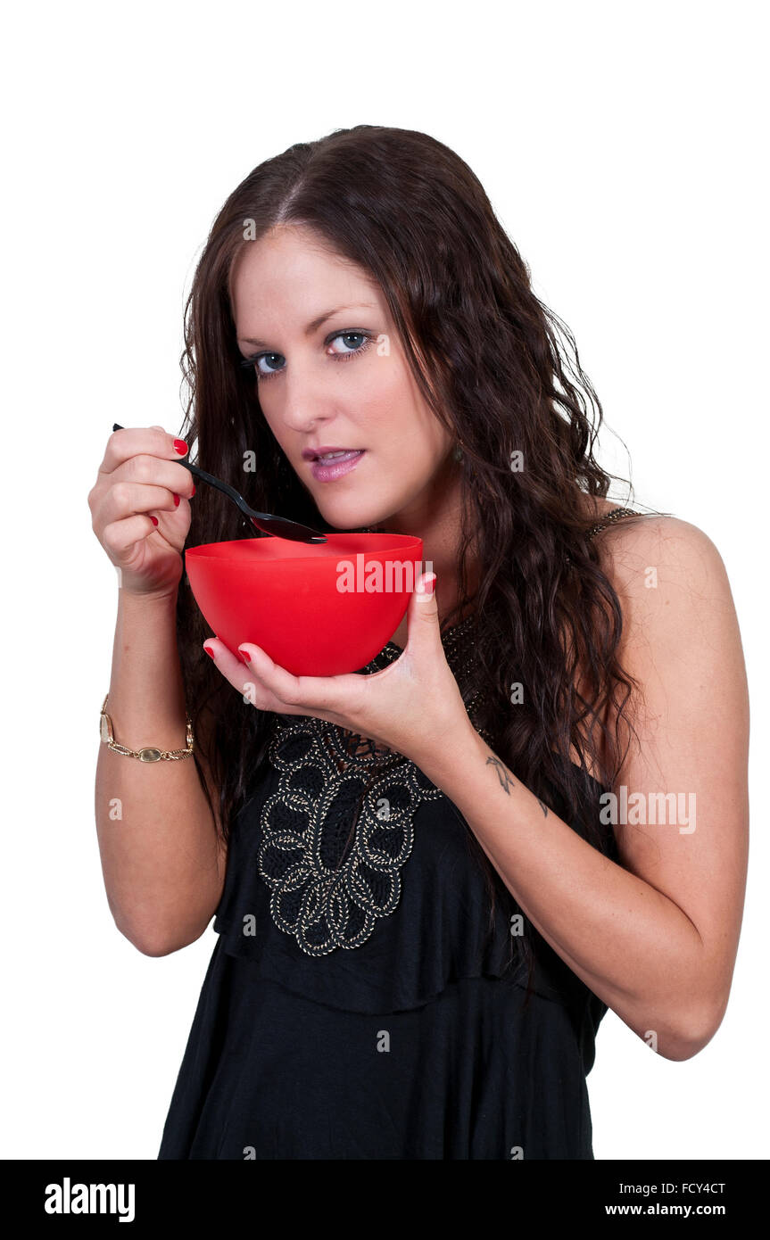 A beautiful woman eating food from a bowl Stock Photo - Alamy