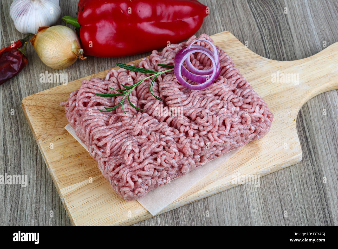 Raw minced pork meat with onion and rosemary ready for cooking Stock ...