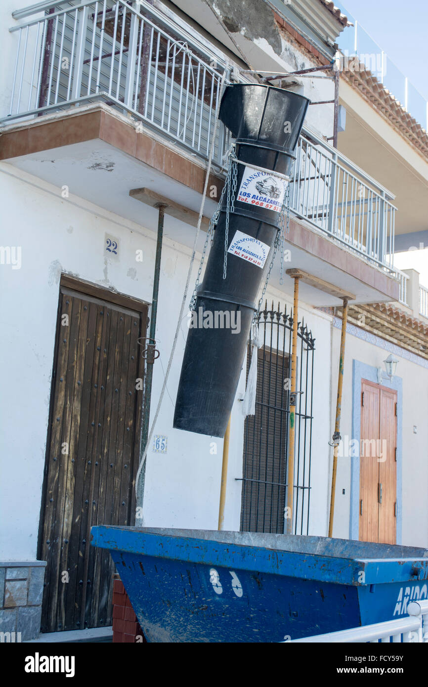 Waste shoot and skip for construction work on a property renovation at ...