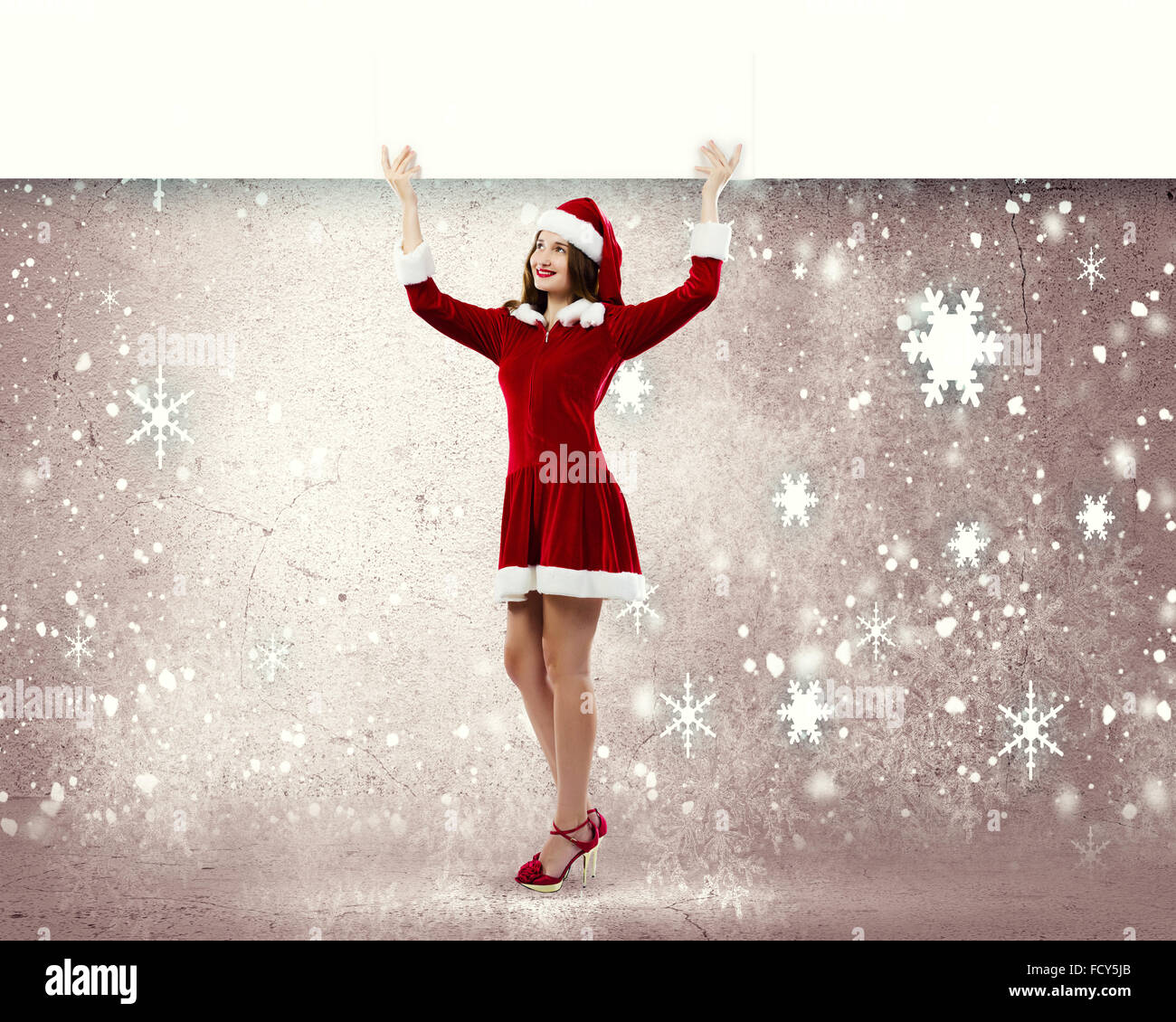 Girl in Santa costume with white blank banner. Place for text Stock ...