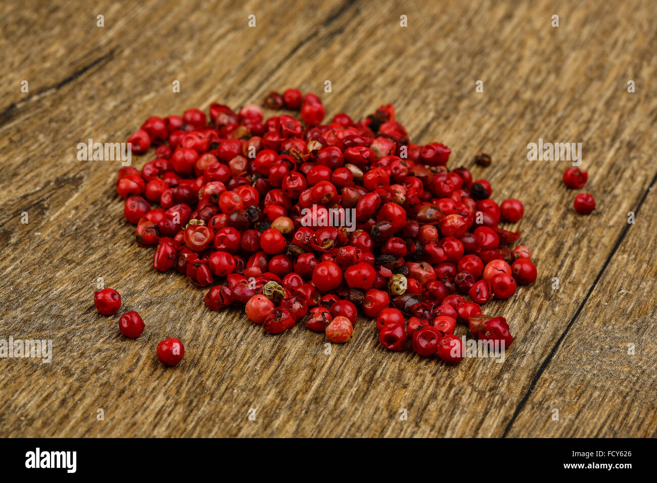 Dry Rose pepper corn on the wood background Stock Photo - Alamy