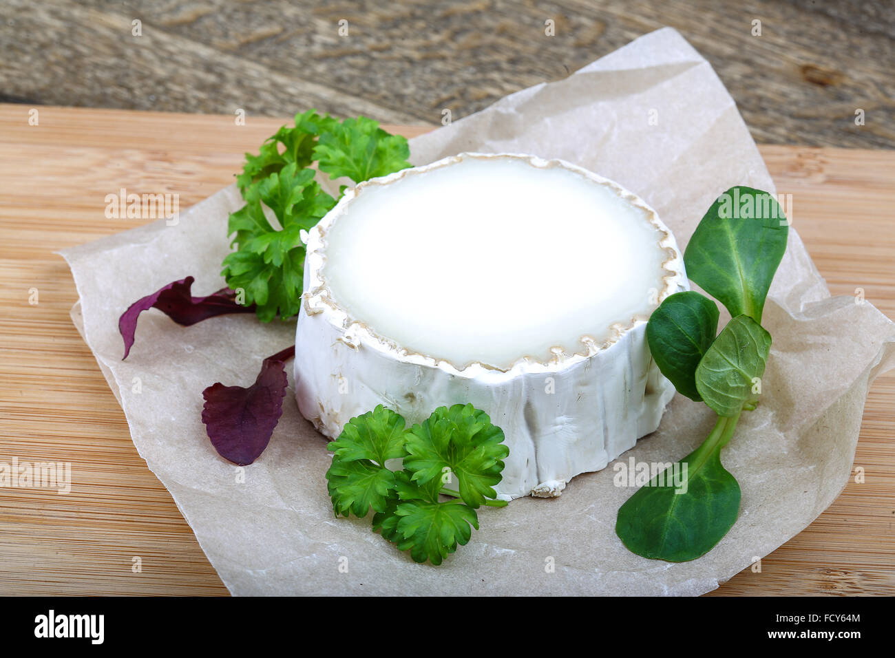 Goat cheese with white mold served parsley leaves Stock Photo - Alamy