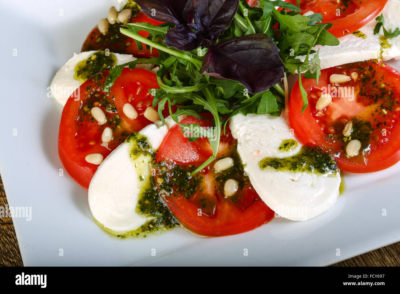 Italian traditional Caprese salad with cedar nuts Stock Photo - Alamy