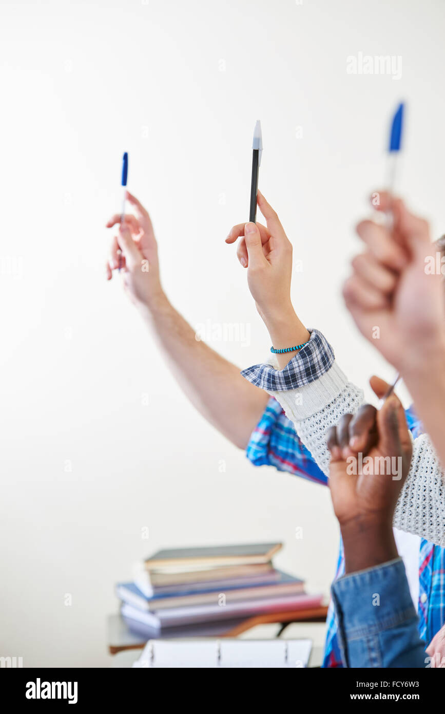 Students with pens in their hands participate in class Stock Photo - Alamy