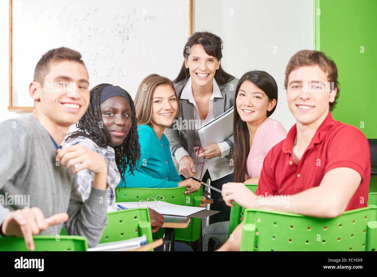 Teenage students with teacher in class at school Stock Photo - Alamy
