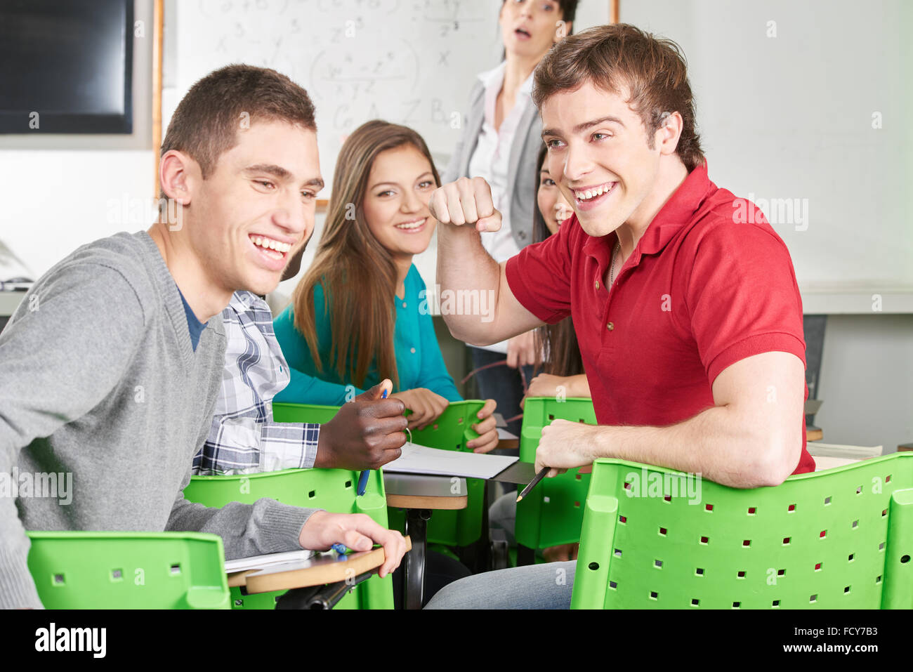 Student with his fist up having fun and making jokes in class Stock ...