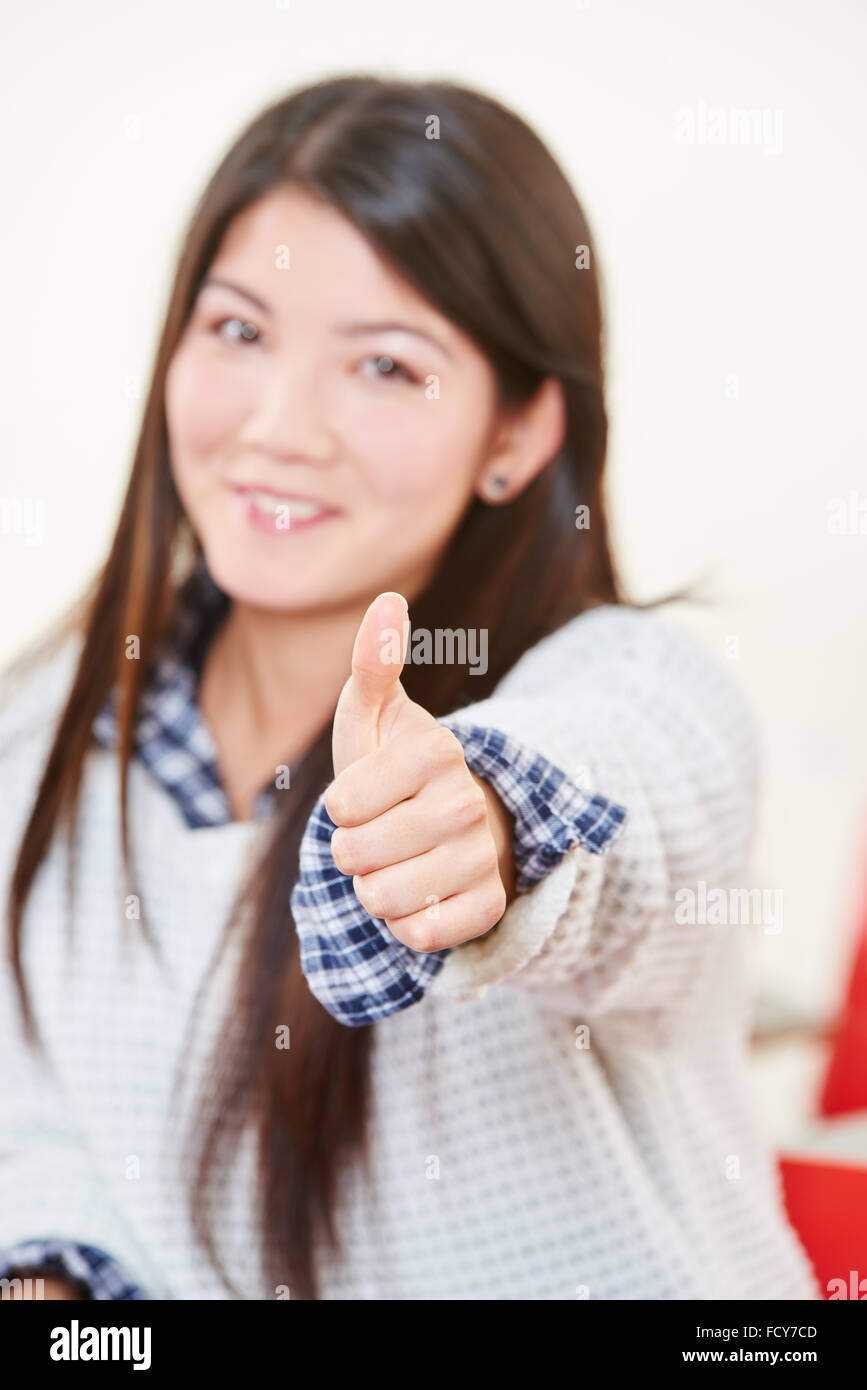 Successful girl with thumbs up gesture at high school Stock Photo - Alamy