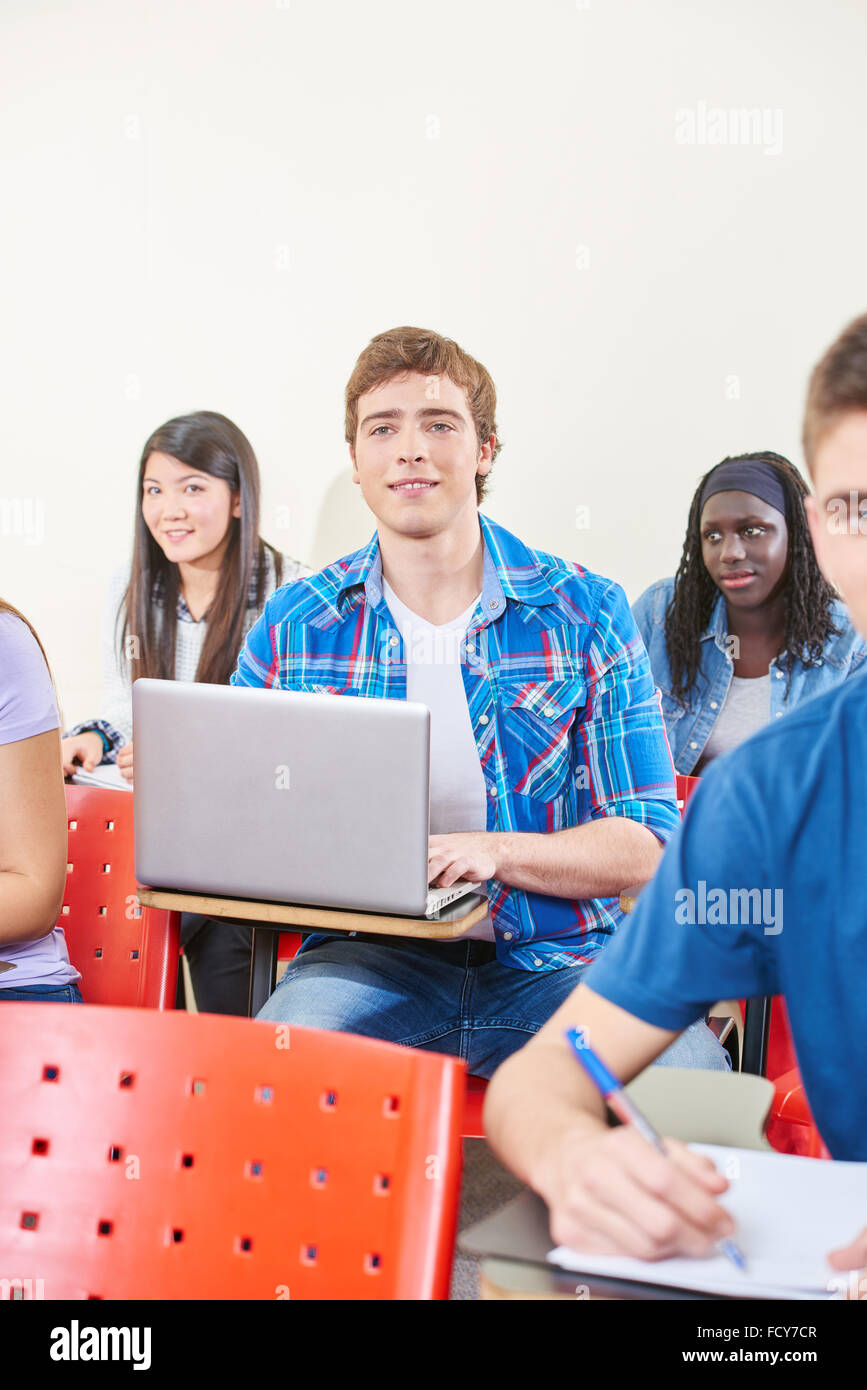 Student taking notes with laptop in class in university Stock Photo - Alamy