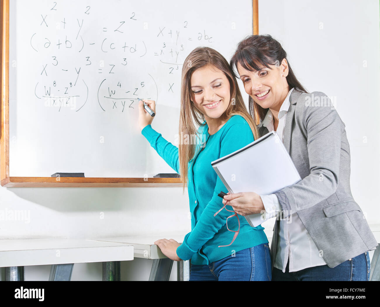 Student ant teacher solve a math problem on the blackboard Stock Photo ...