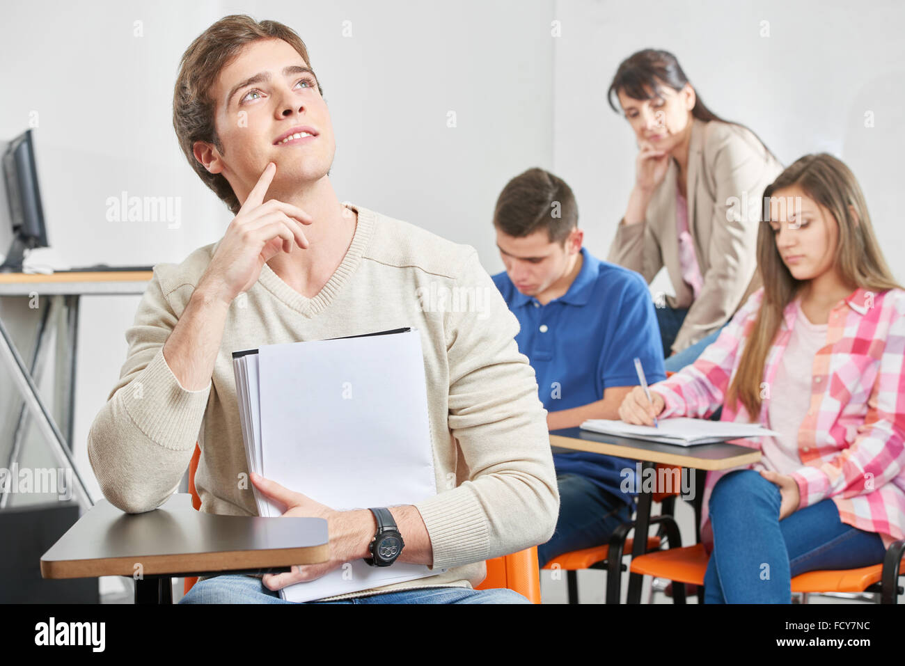 Pensive teenage student in class looking up thinking deeply Stock Photo ...